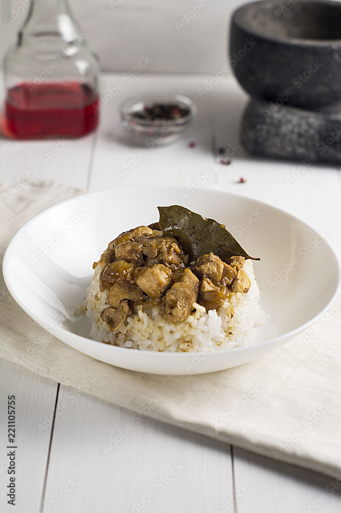 chicken and pork adobo over yellow rice, filipino food Stock Photo ...