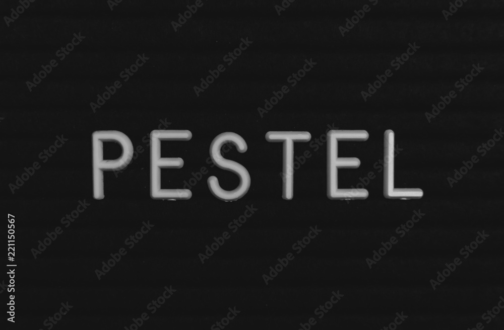 Word pestel written on the letter board. White letters on the black ...