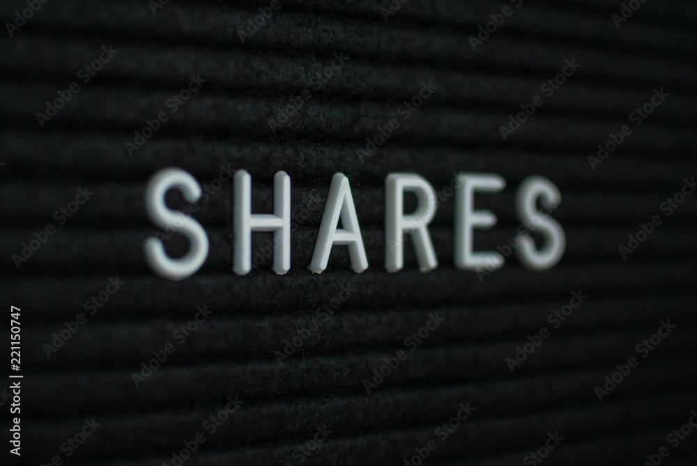 Word shares written on the letter board. White letters on the black ...