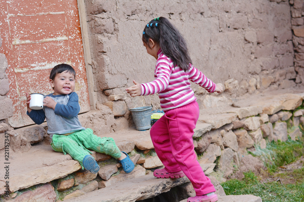 Happy latin kids playing in the countryside. Little boy doesnt want to ...