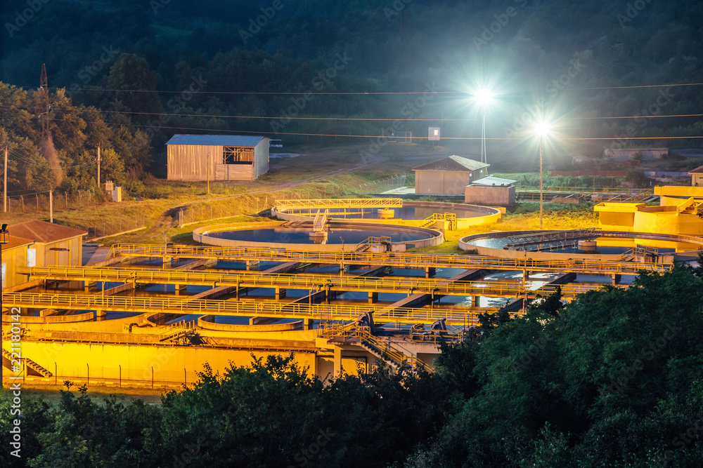 Modern industrial wastewater treatment plant at night. Aerial view of ...