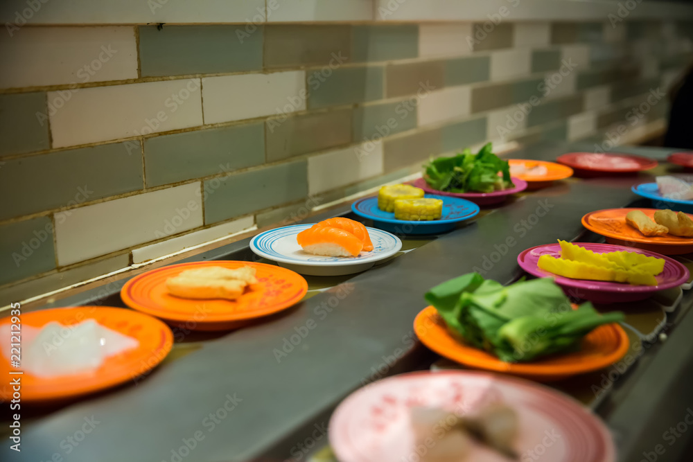 Row of dishes in belt japanese food buffet. trendy popular restaurants ...