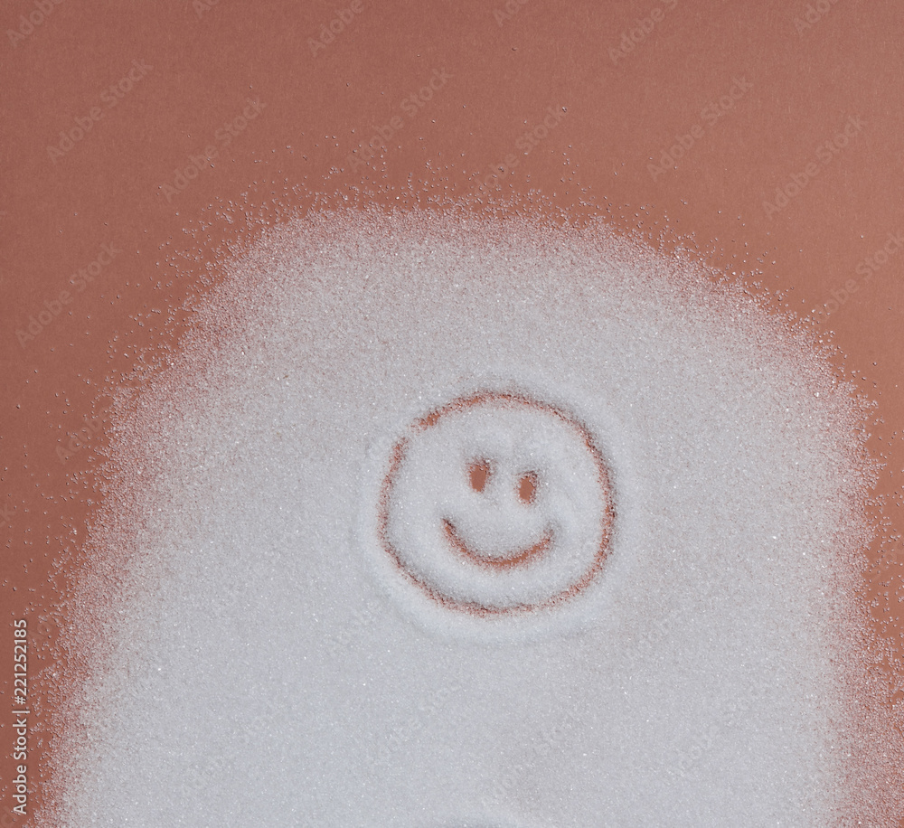 Smiley face in sugar on orange background Stock Photo | Adobe Stock