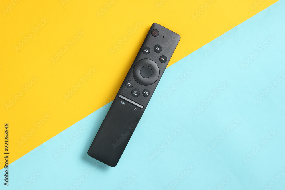 A modern TV remote control on pastel background. Top view, minimalism ...