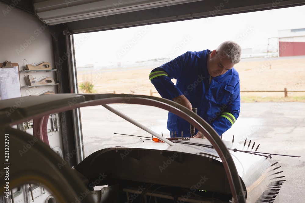 Engineer tightening screw on airplane parts Stock Photo | Adobe Stock