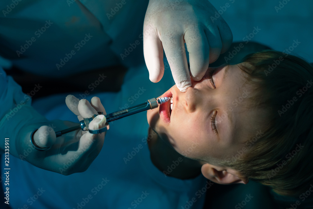 Closeup of dentist making anesthetic injection to young boy Stock Photo ...