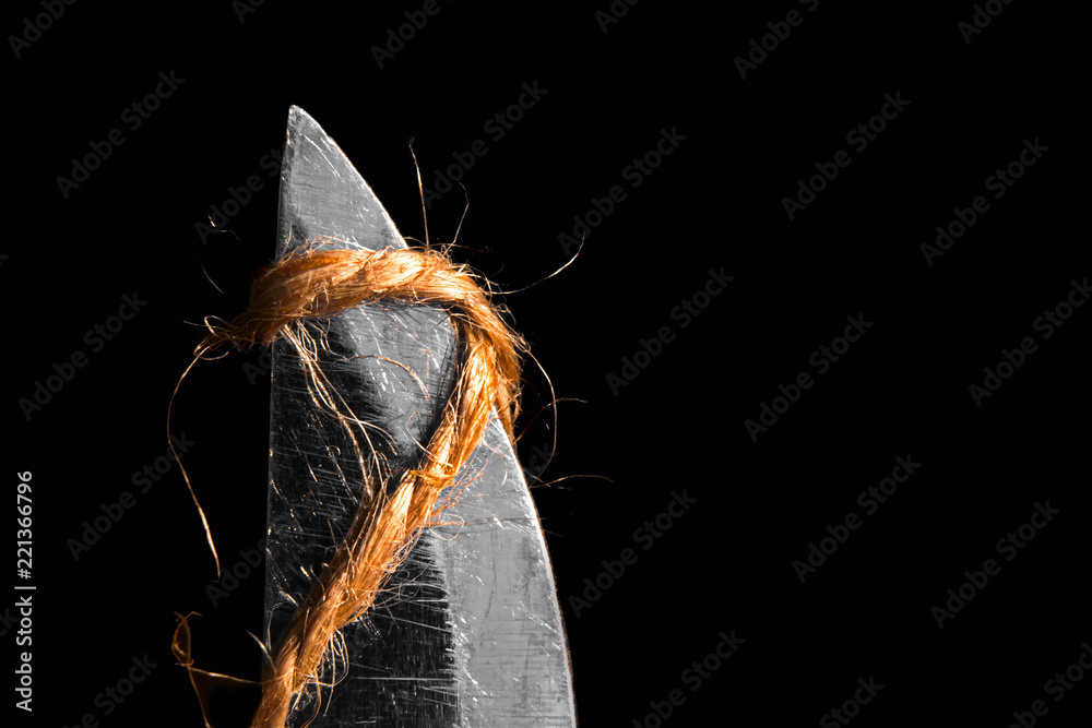 Blade of a knife cuts a jute rope is macro Stock Photo | Adobe Stock