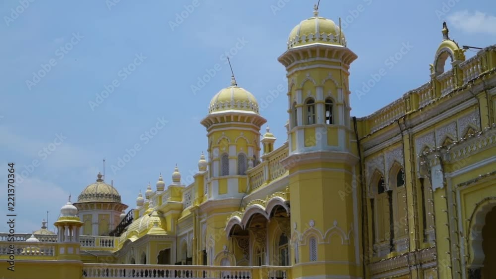 Two bright yellow towers stretching out from a bright yellow wall in ...