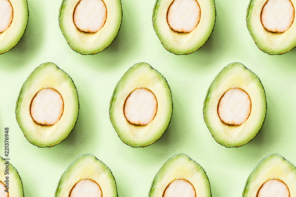 Avocado on green background. Tropical abstract background with avocado ...