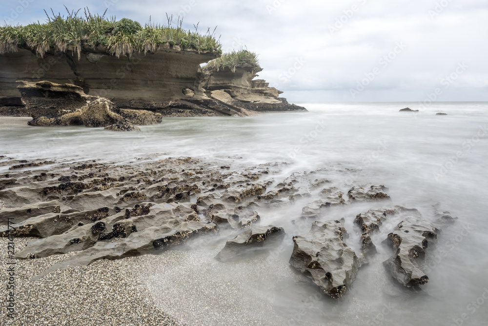 Strange eroded rock on the beach at the end of the Truman Track near ...