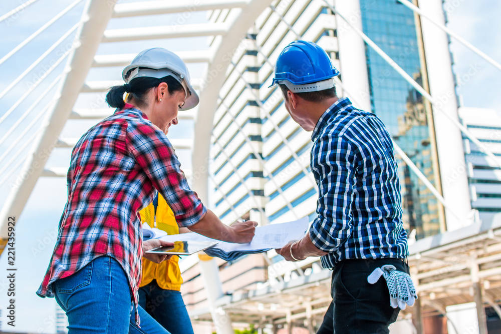Three industrial engineer wear safety helmet engineering working and ...