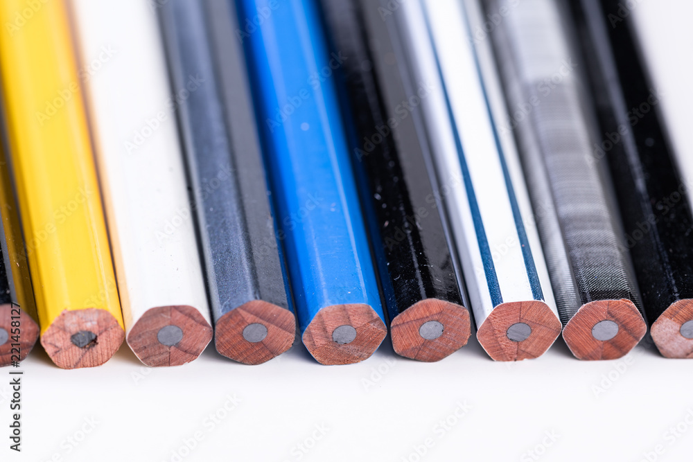 Several unsharpened new graphite pencils of different colors and ...