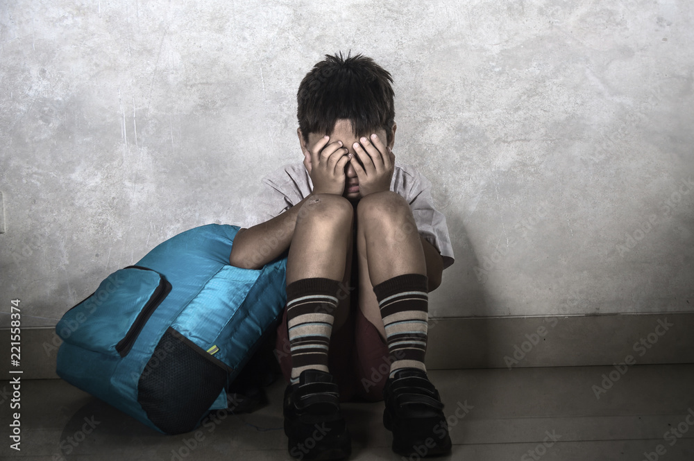 young sad scared kid 8 years old in school uniform and backpack sitting ...