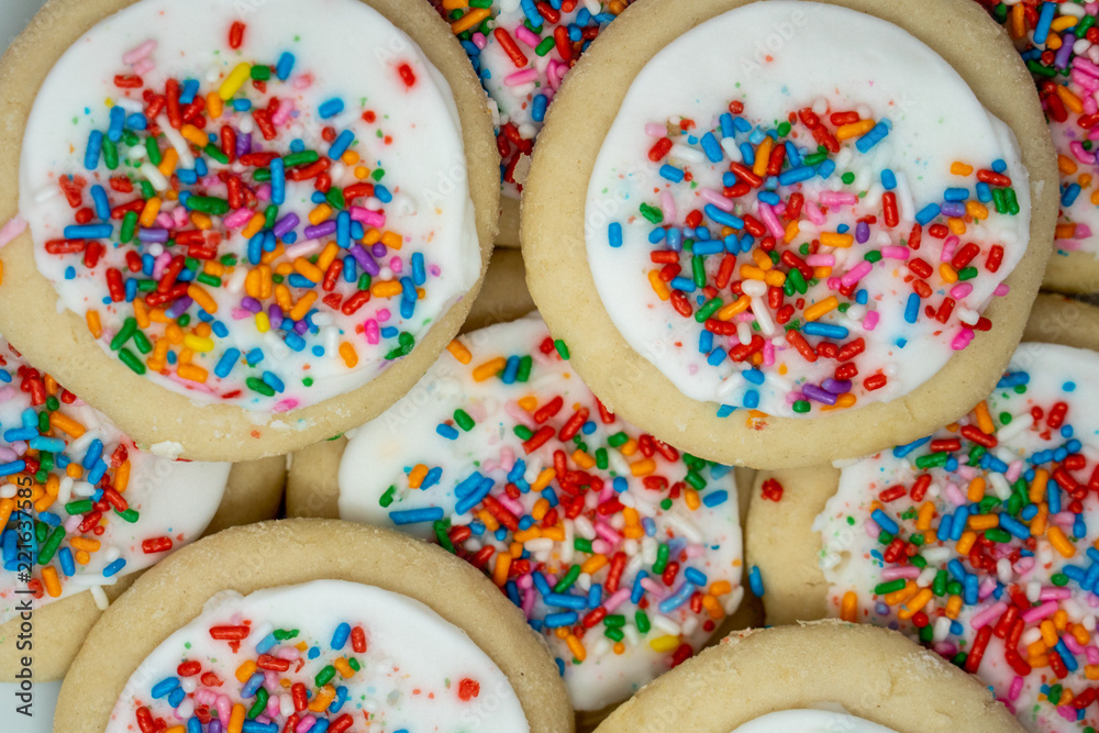 Delicious vanilla circle shaped frosted sugar cookies with colorful ...