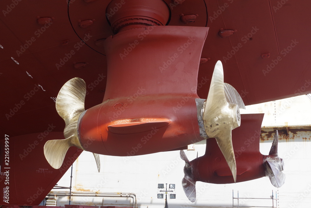 Double propellers on a massive supply vessel. Ship in a dry dock for ...