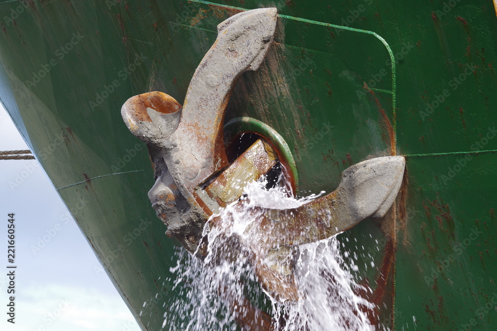 Huge and massive anchor in resting position with water over flooding ...