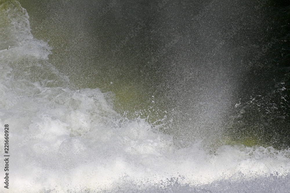 Splashes and spray from waterfall. Big water splash in lake after ...