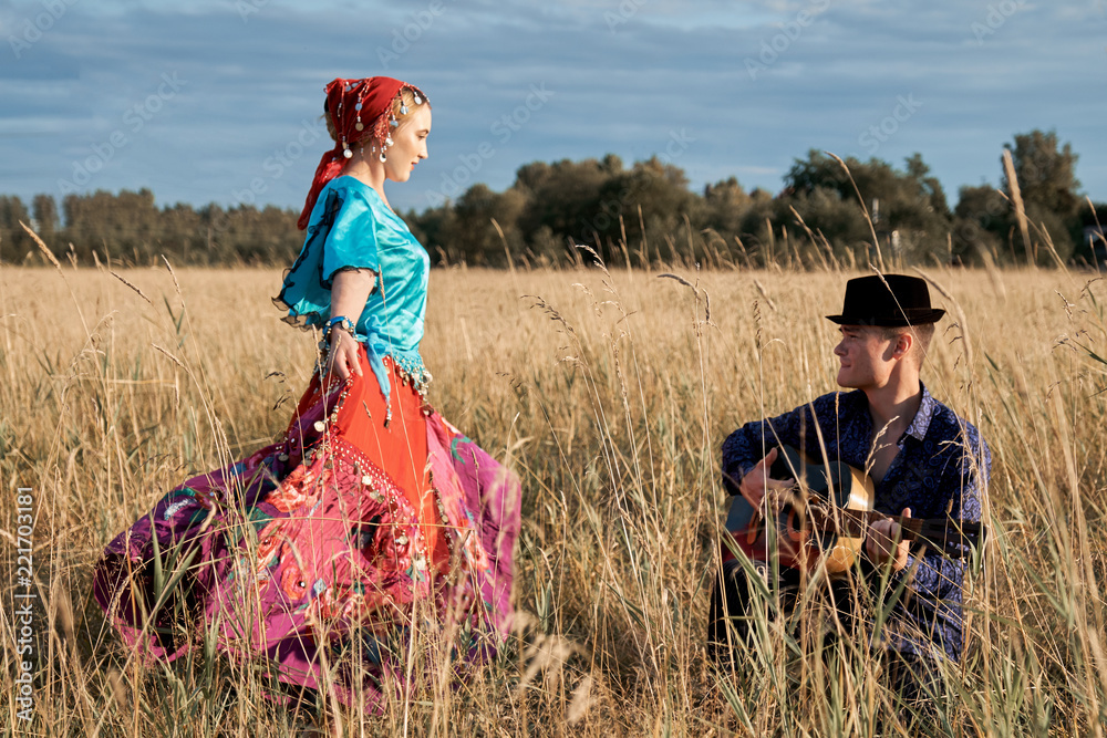 gipsy woman dancing near gypsy man who playing guitar. Lifestyle ...