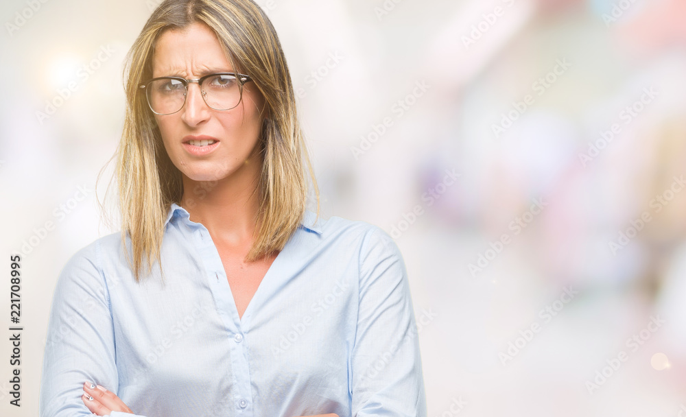 Young beautiful business woman over isolated background skeptic and ...