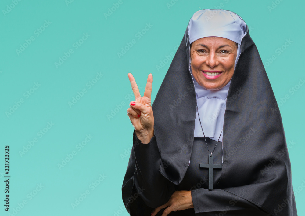 Middle age senior christian catholic nun woman over isolated background ...
