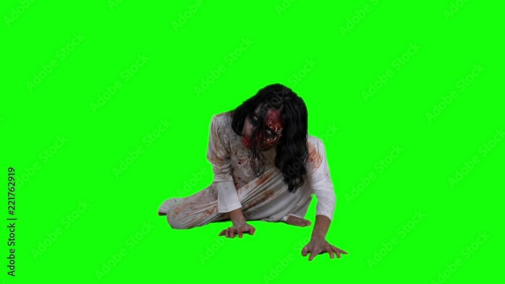 Scary undead zombie woman with wounded face crawling in the studio ...