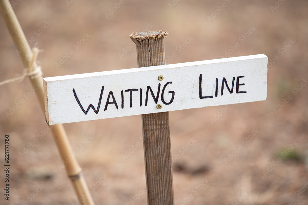 Sign on the Wooden stick with "Waiting Line" wording on it. Stock Photo ...