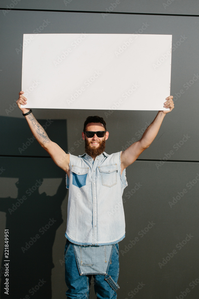 Hipster man holding a poster Stock Photo | Adobe Stock