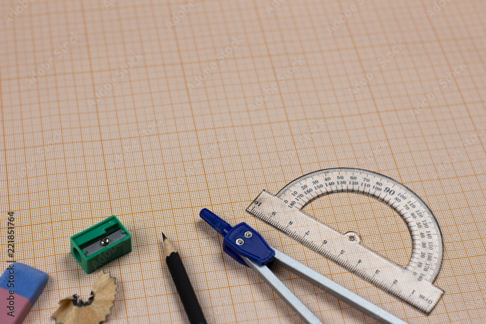 A close-up photo of stationary set: pen, pencil, compass, rubber ...