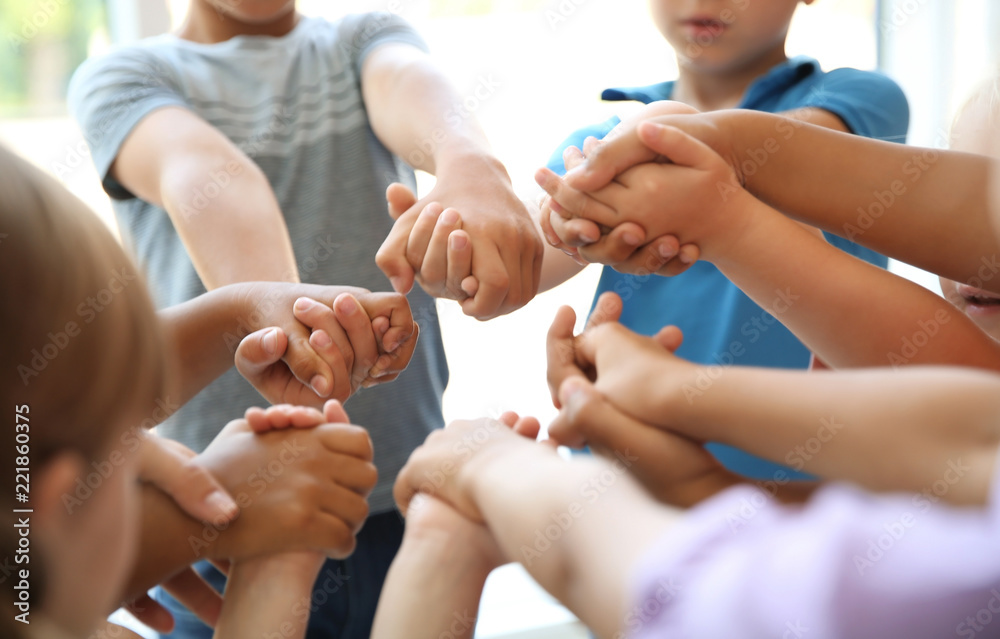 Little children holding their hands together, closeup. Unity concept ...