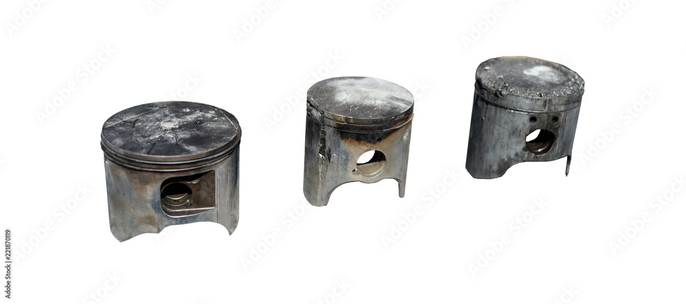 Burned, damaged car pistons. Isolated on a white background with a ...