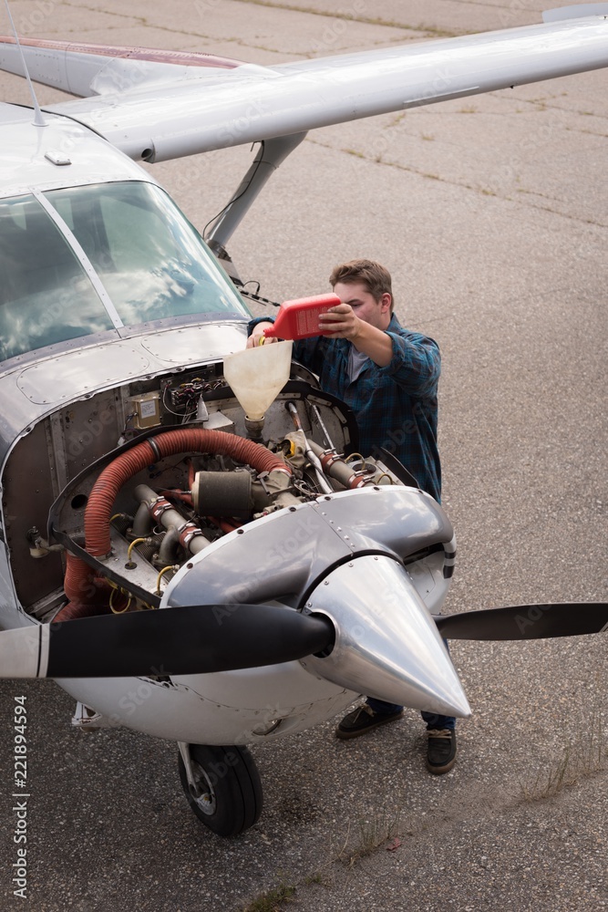 Engineer filling oil in aircraft engine Stock Photo | Adobe Stock
