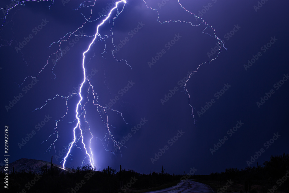 Lightning bolt strikes a hillside during a storm near Tucson, Arizona ...