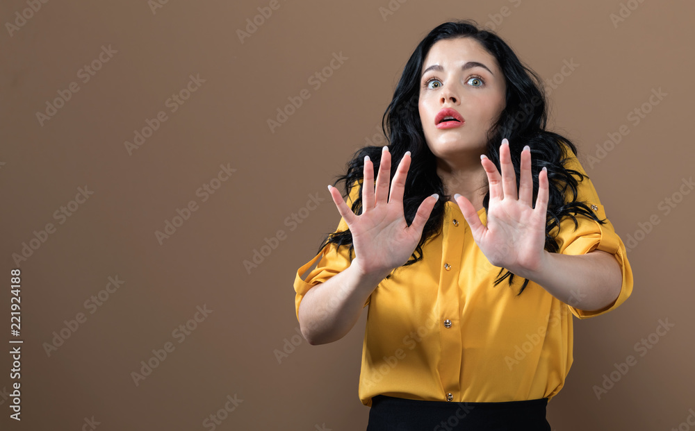 Scared young woman on a solid background Stock Photo | Adobe Stock