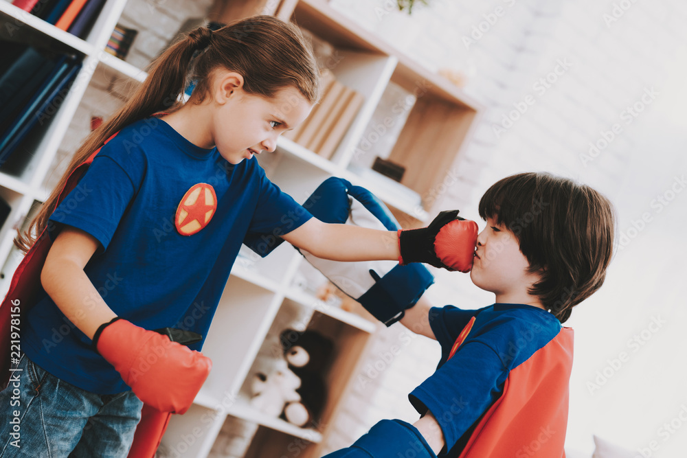Children In Gloves Are Boxing In Superhero Suits. Stock Photo | Adobe Stock
