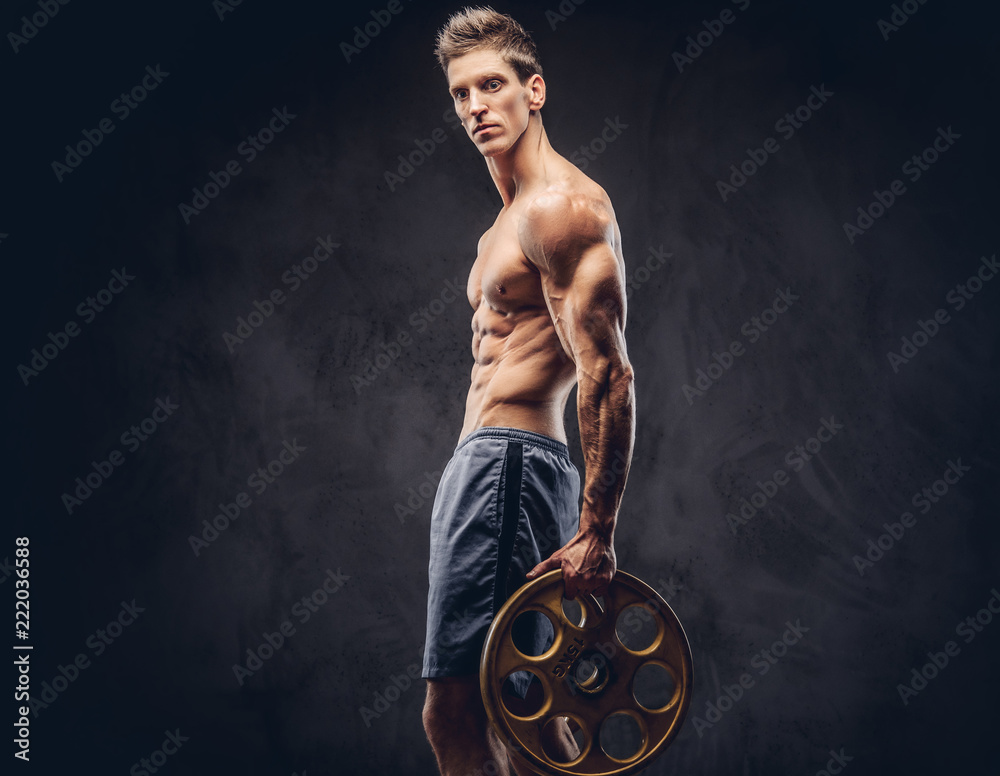 Handsome shirtless ectomorph bodybuilder with stylish hair posing with ...