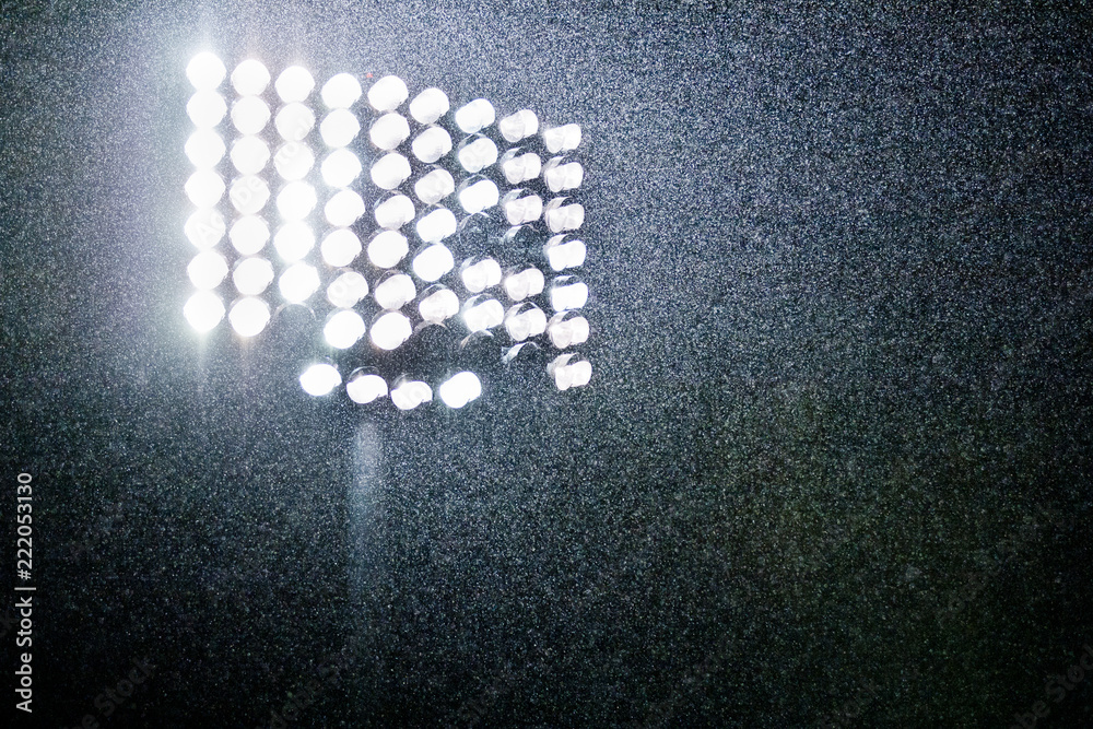 Heavy rainfall under the bright lights of a sports stadium Stock Photo ...