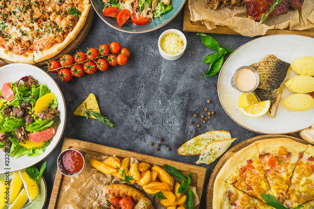 Tasty food - grilled pork ribs, pizza, salads, fish and sausages with ...