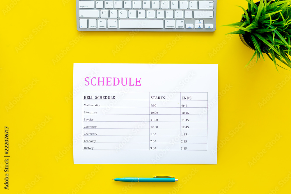 School student's schedule with time of lessons on yellow office desk ...