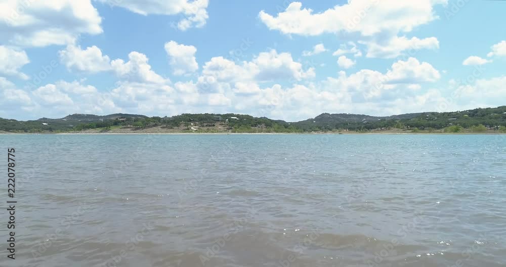 Aerial shot starting just above water surface and flying out while ...