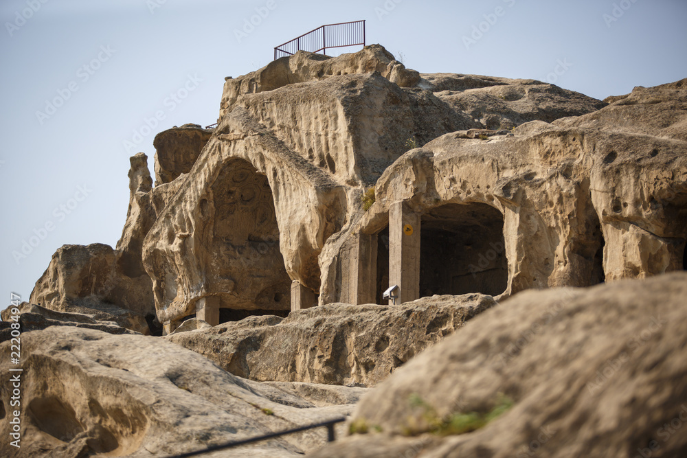 Ancient stone cave city of Uplistsikhe in Georgia. Brown stone ruins ...