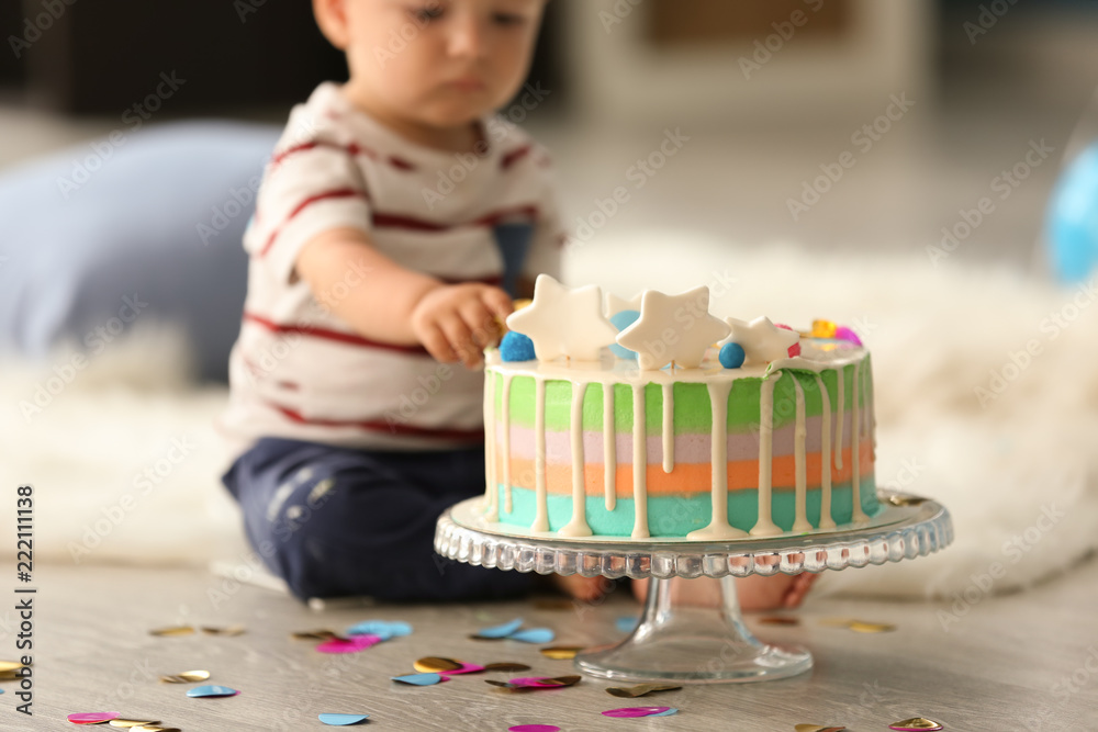 Cute little boy with birthday cake sitting on floor in room Stock Photo ...