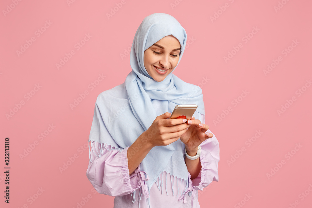 Happy arab woman in hijab with mobile phone. Portrait of smiling girl ...