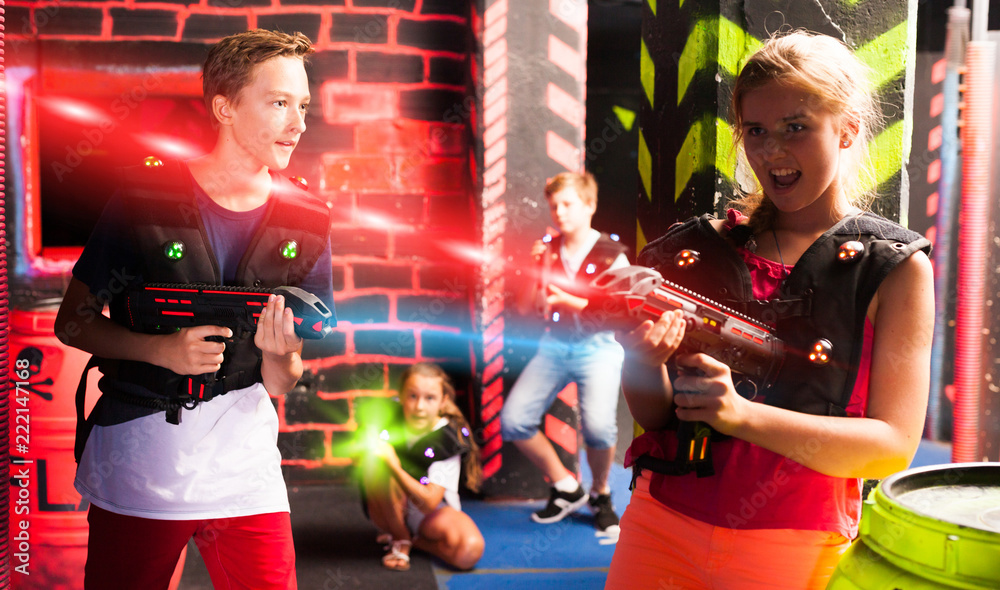 Girls and boys playing laser tag Stock Photo | Adobe Stock
