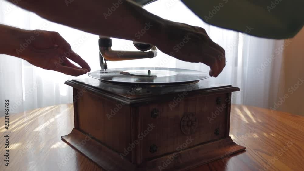 Place a record on an old antique record player Gramophone Phonograph to ...