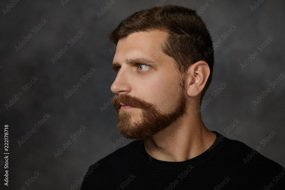 Profile portrait of attractive macho man with neat trimmed beard and ...