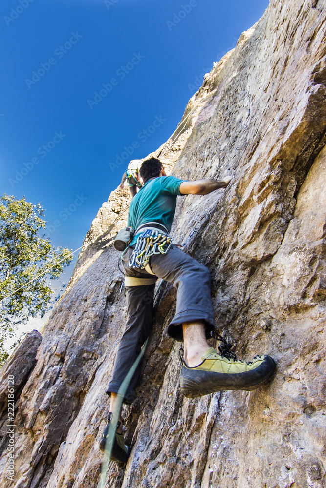 The last movements to reach the summit by a male climber. Rock climbing ...