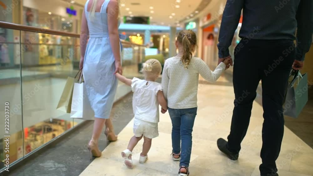 Happy family of four doing shopping. Family in mall. Children At Mall ...
