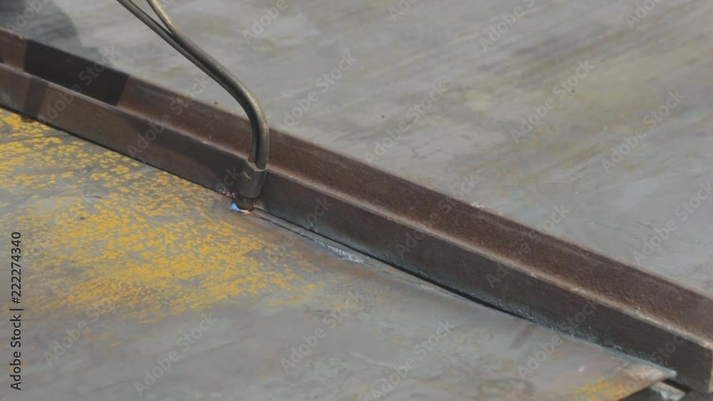 Cutting metal products with a gas cutter, the worker cuts a metal sheet ...