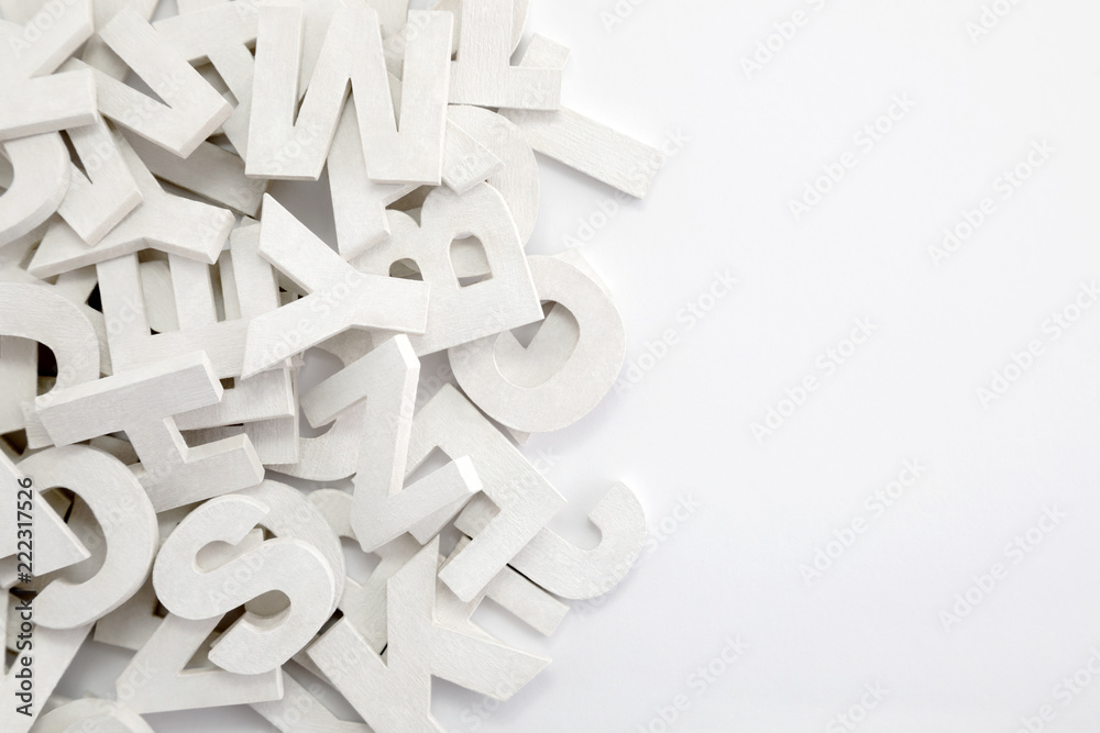 Pile of white painted wooden letters. Typography background composition ...