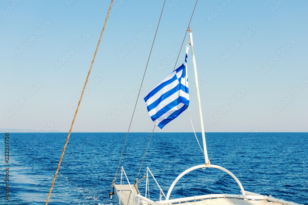 Greek flag waving at the back of a boat Stock Photo | Adobe Stock